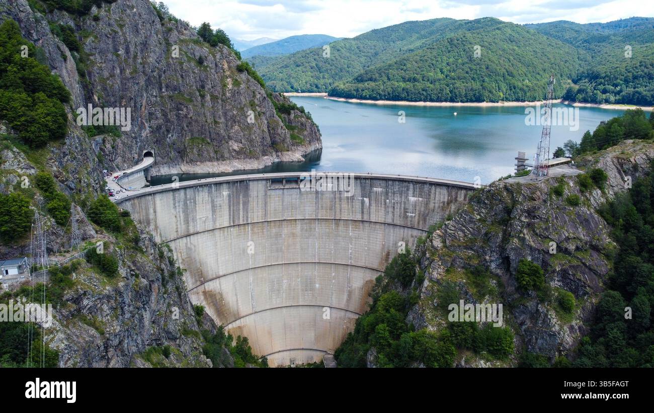 Massive Concrete Dam Between Mountain Ranges Holding a Vast Reservoir ...