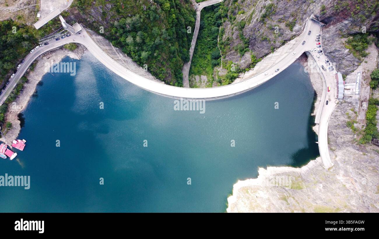 Top Down Aerial View of Curved Dam Nestled Between Mountains Stock ...