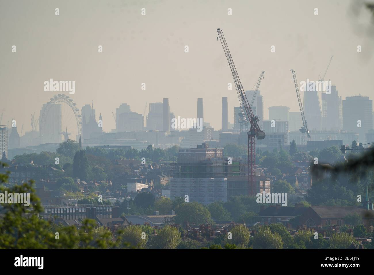 London UK 2 May 2025. The London Eye and Battersea power station in ...