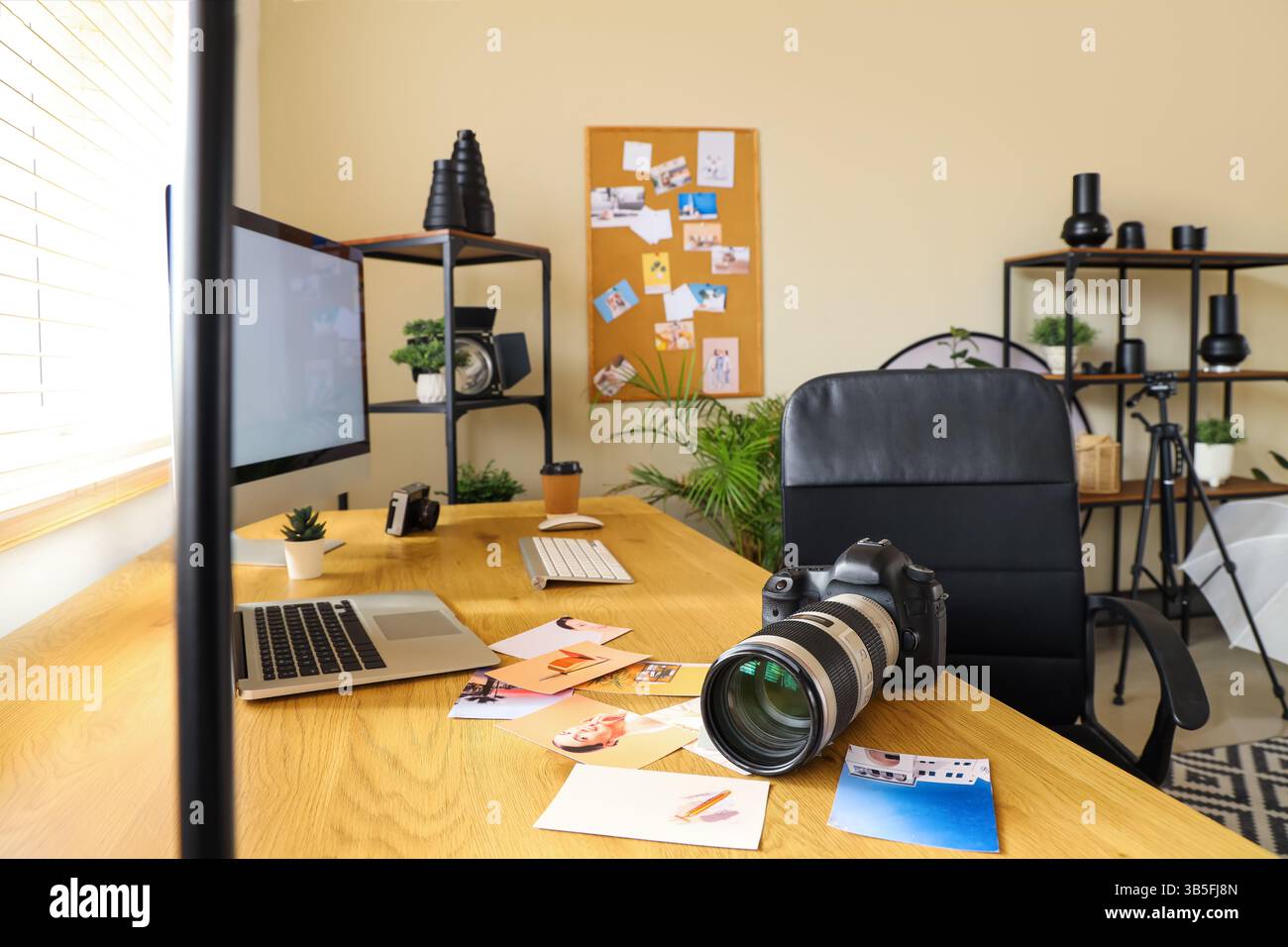 Camera with laptop and computer on photographer's table in office Stock ...