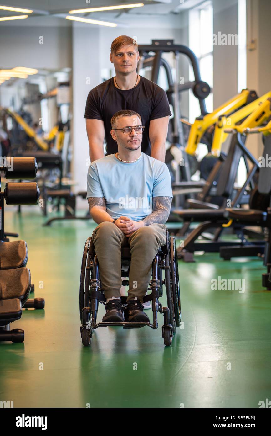 Motivated disabled man in wheelchair heading to workout session with ...