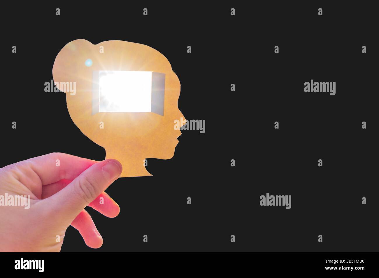 Paper cutout of a woman's head in profile, with shutters in her head ...