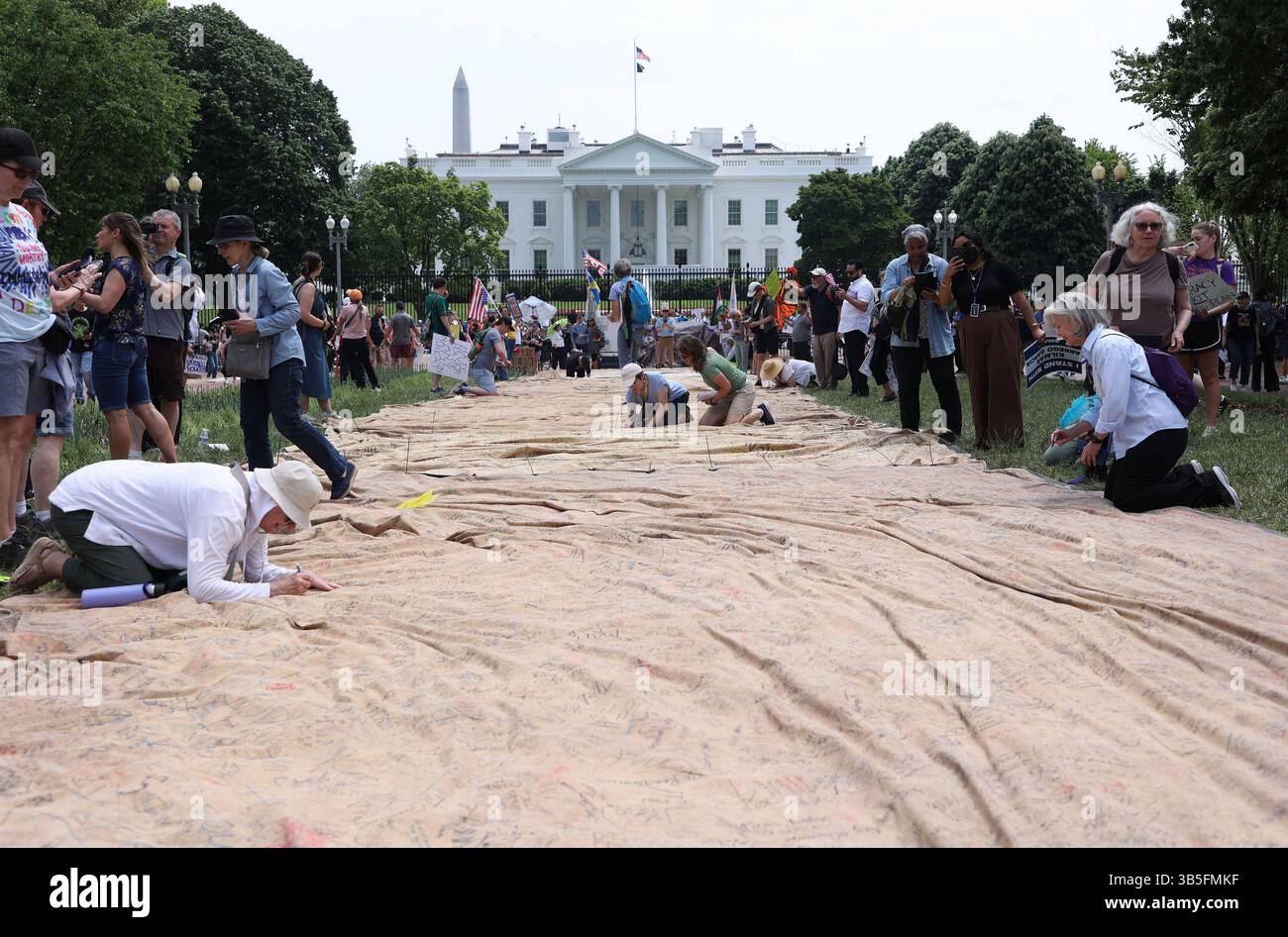 May Day Protest in Washington, USA Protesters sign a replica of the ...