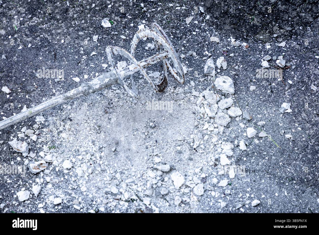 Mixing glue and mortar for gluing tiles on a terrace, container and ...