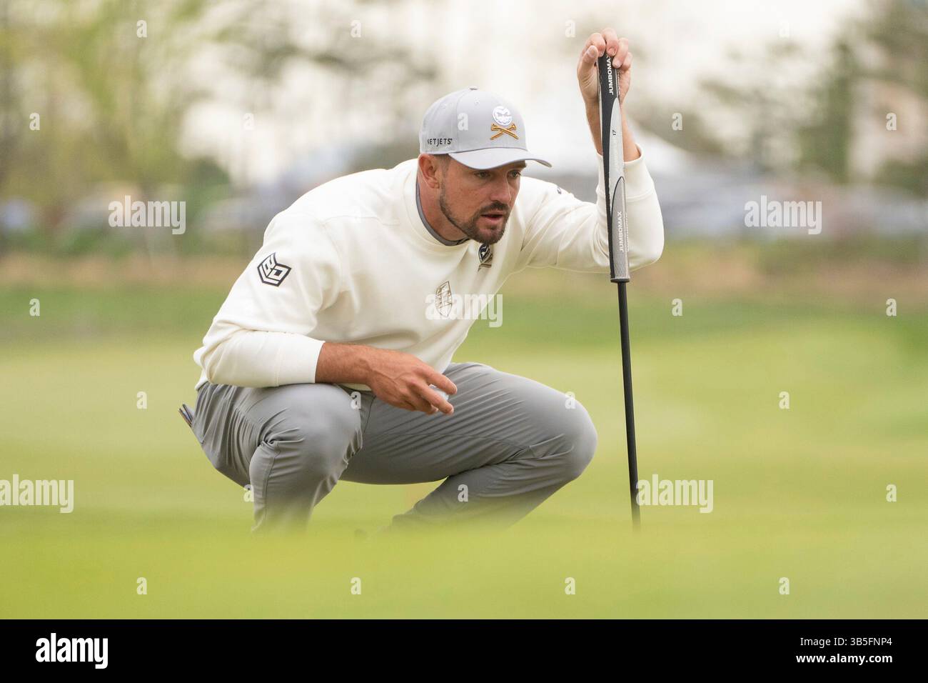 Captain Bryson DeChambeau of Crushers GC reads his putt on the 18th ...