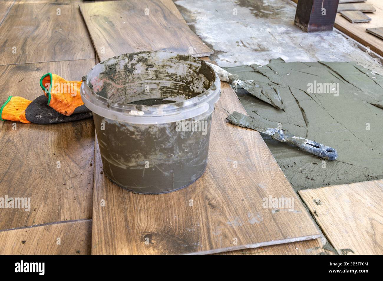 Laying tiles on a terrace in the garden, gluing tiles with frost ...