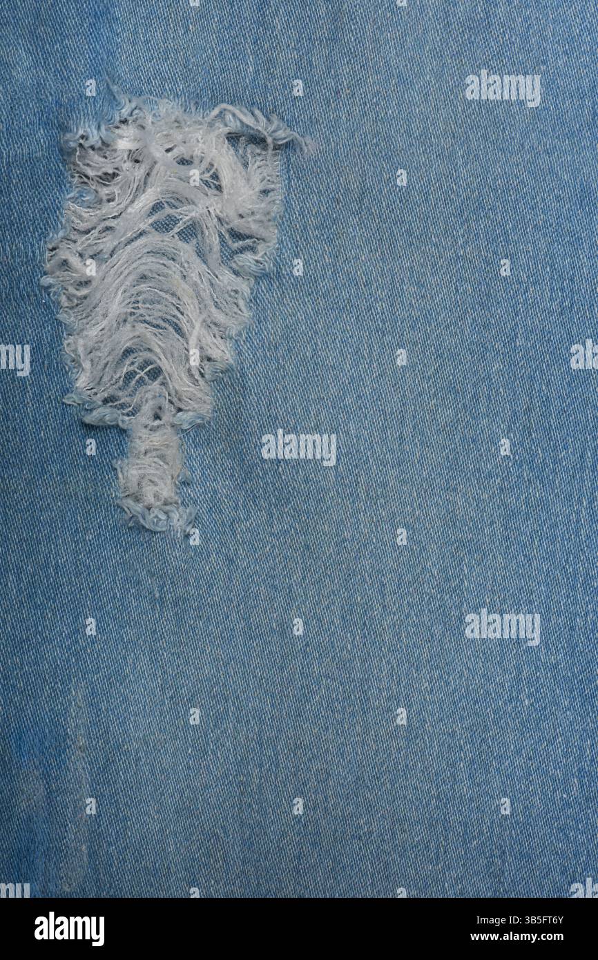 Ripped blue hipster jeans material. Destroyed denim Cloth texture ...