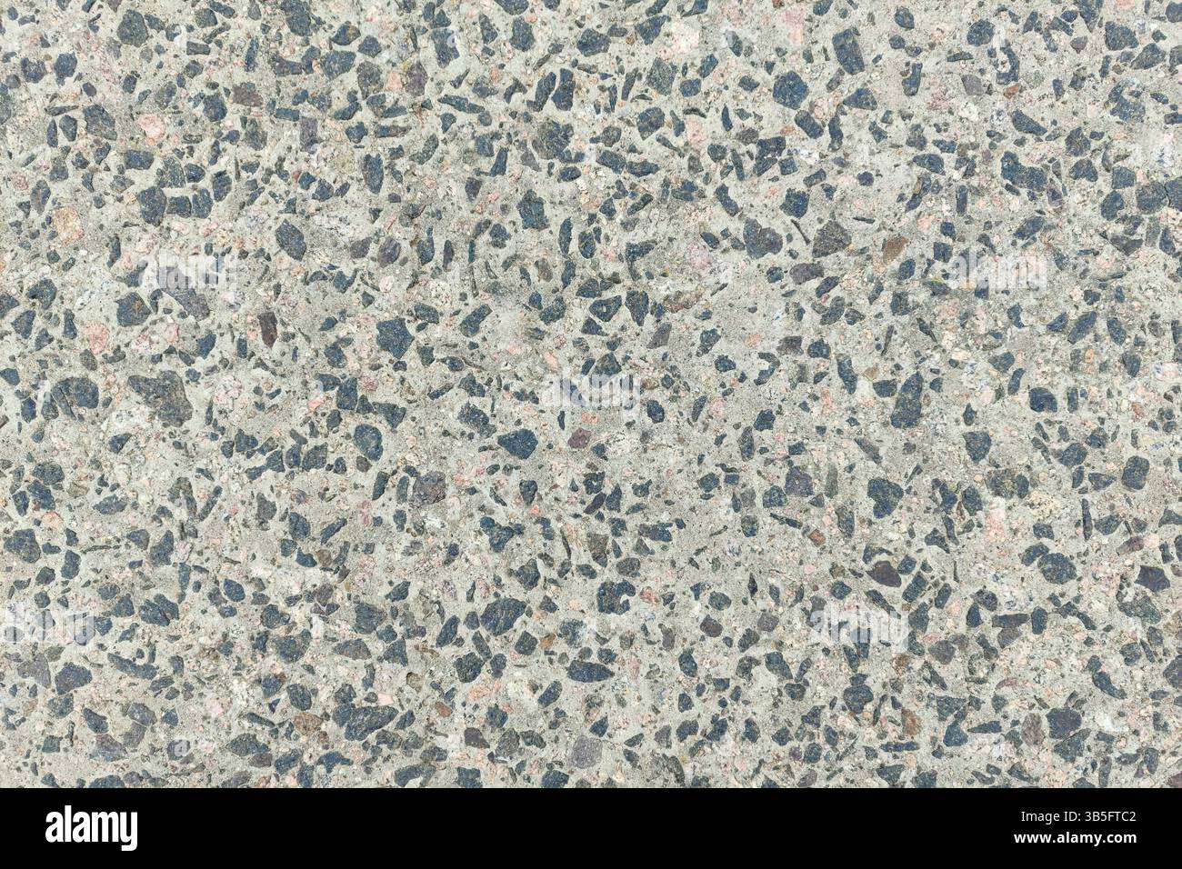 Concrete texture. Pebbles of different colors and signs of aging are ...