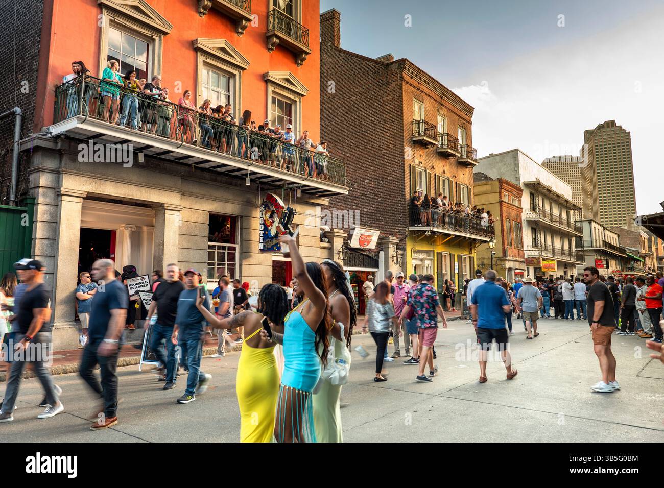 New Orleans Louisiana people throw beads from a bar on Bourbon Street ...