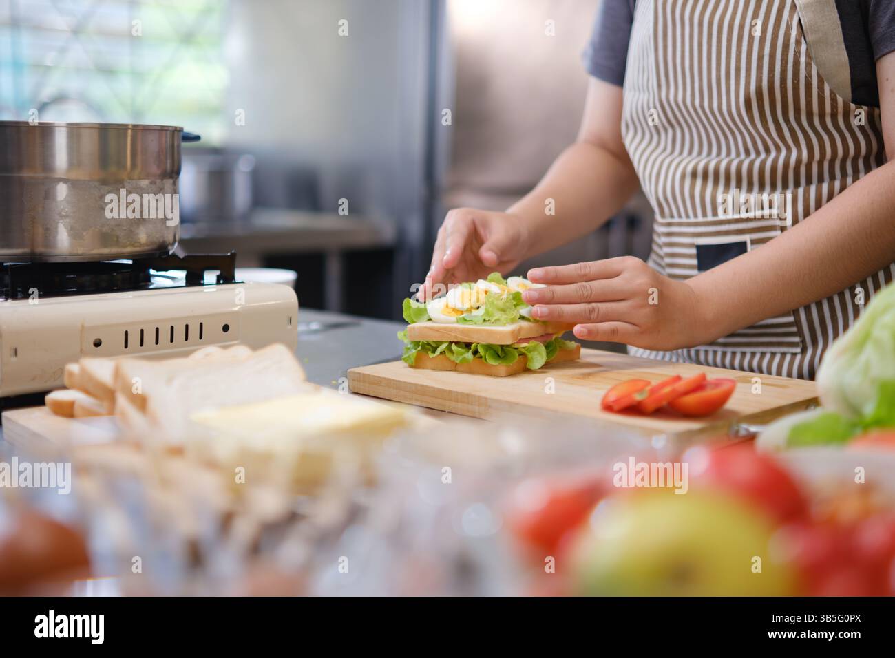 Focused chef carefully a gourmet sandwich Stock Photo - Alamy