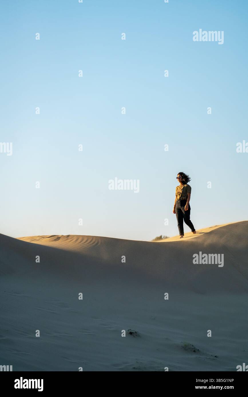 Young woman walking on sand dune in the desert enjoying freedom Stock ...