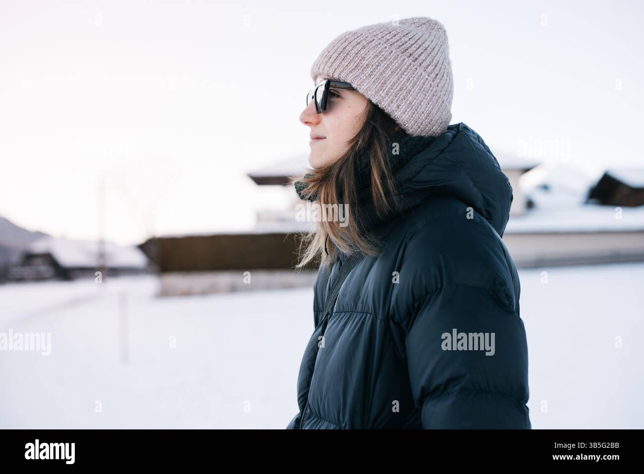 Woman in profile wearing winter coat in Tyrol village Stock Photo - Alamy