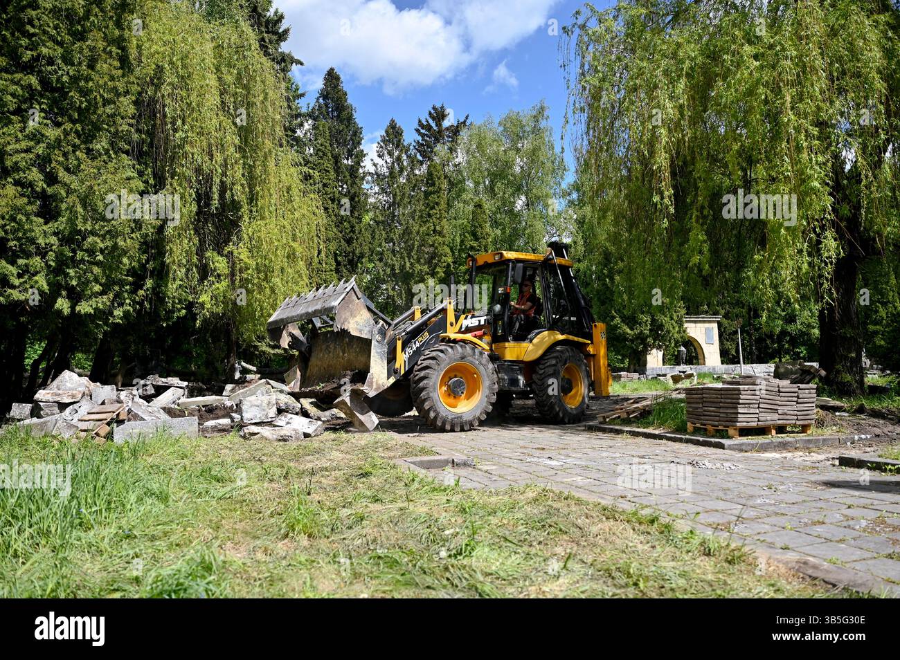 A tractor is used to research and exhume Soviet burials at the Hill of ...