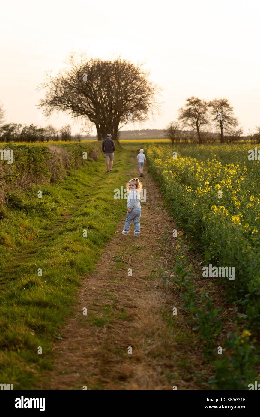toddler girl looking back at the camera Stock Photo - Alamy