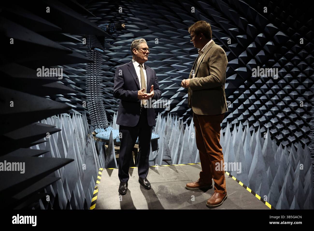 Britain's Prime Minister Keir Starmer, left, is shown an anechoic ...