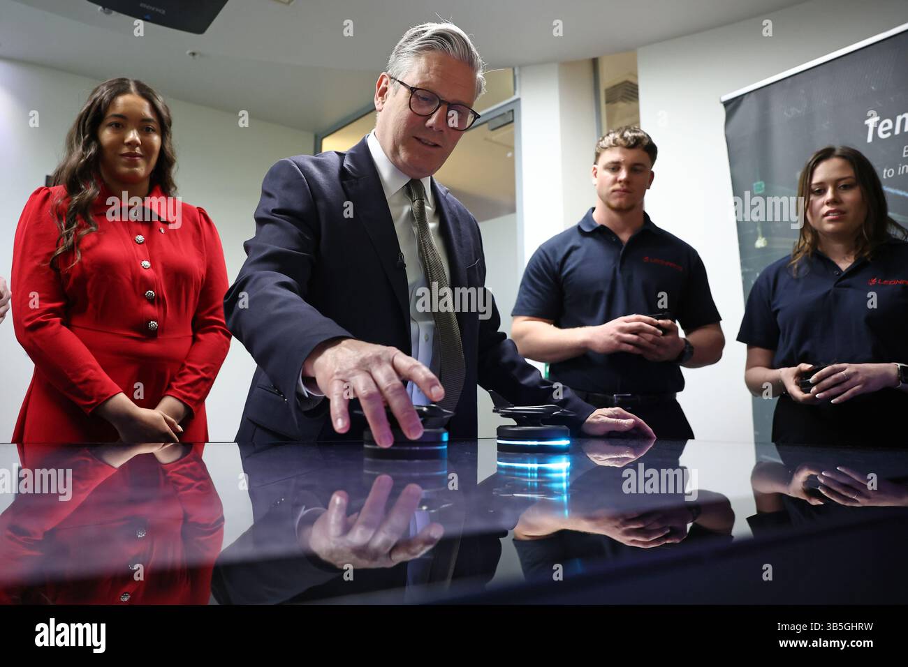Prime Minister Sir Keir Starmer (second left) uses an interactive map ...