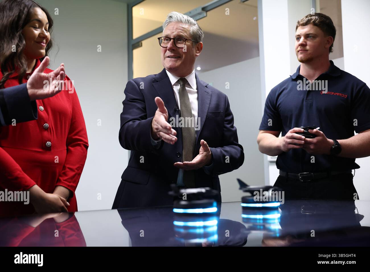 Prime Minister Sir Keir Starmer (centre) is shown an interactive map ...
