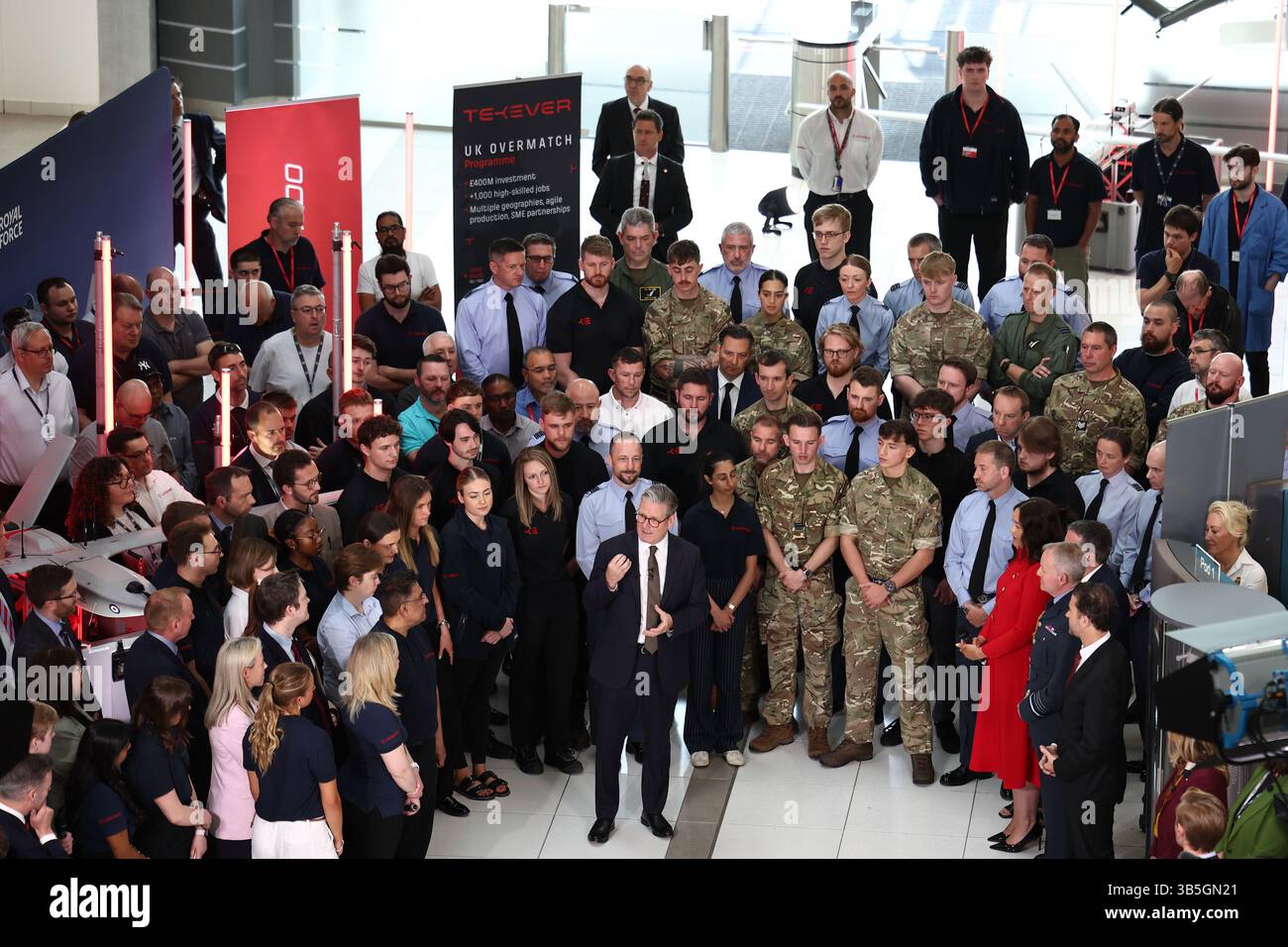 Prime Minister Sir Keir Starmer (centre) speaks to members of staff during a visit to Leonardo ...