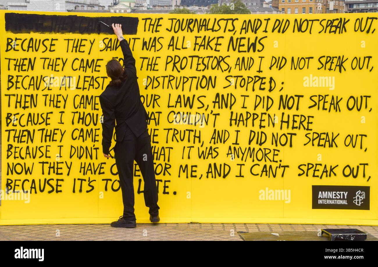 London, UK. 2nd May 2025. An artist redacts a statement adapted from ...
