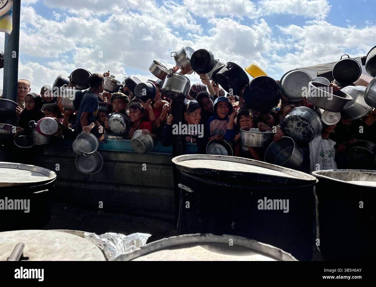 Long queues formed during the distribution of food by an aid ...