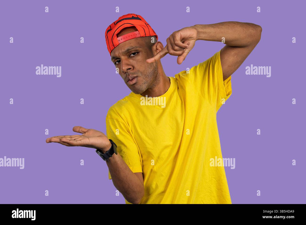 Rapper pointing to his head and shrugging shoulders with confused ...