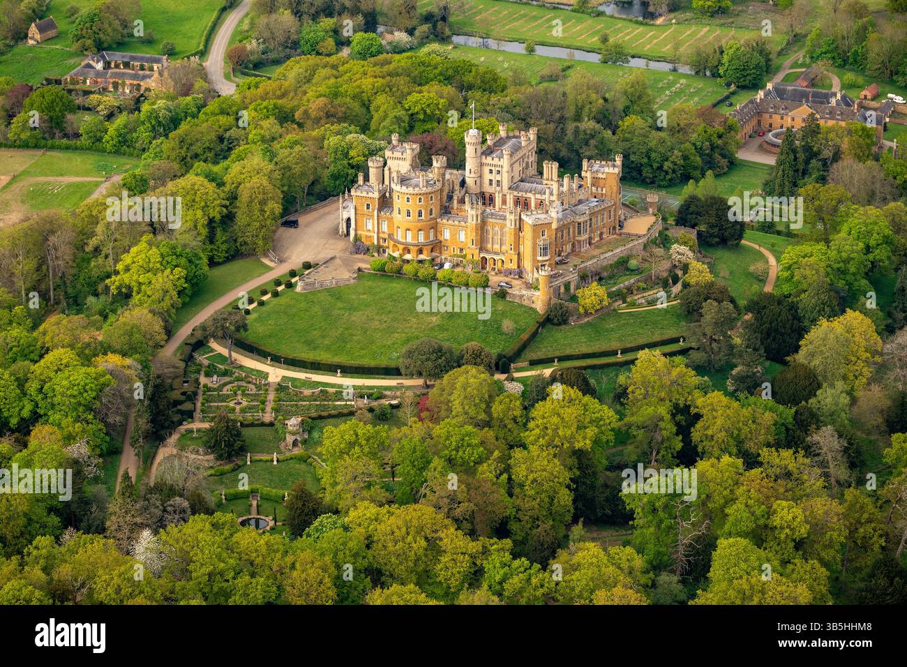 Aerial photograph of Belvoir Castle surrounded by trees in full leaf ...