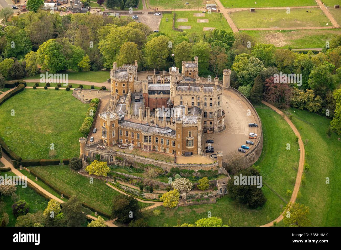 Aerial photograph of Belvoir Castle surrounded by trees in full leaf ...