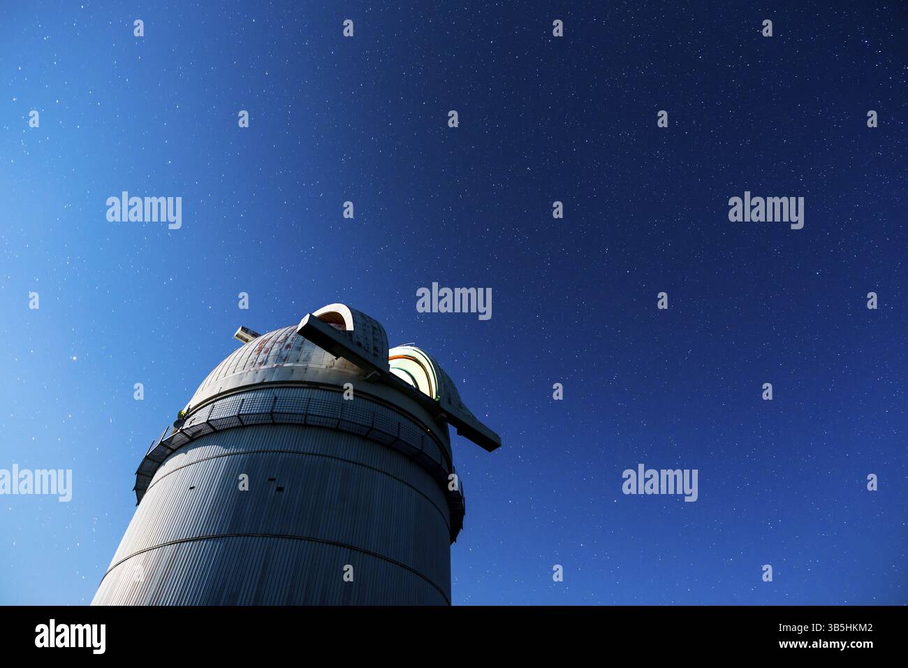 Rozhen astronomical observatory under the night sky stars. Blue sky ...