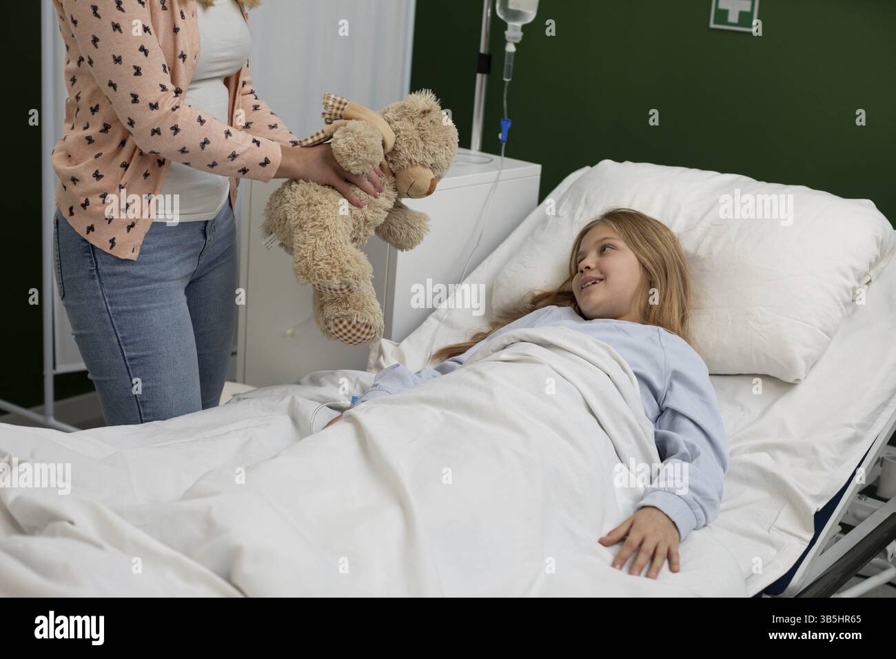 A warm and nurturing scene of a child in a hospital bed receiving ...