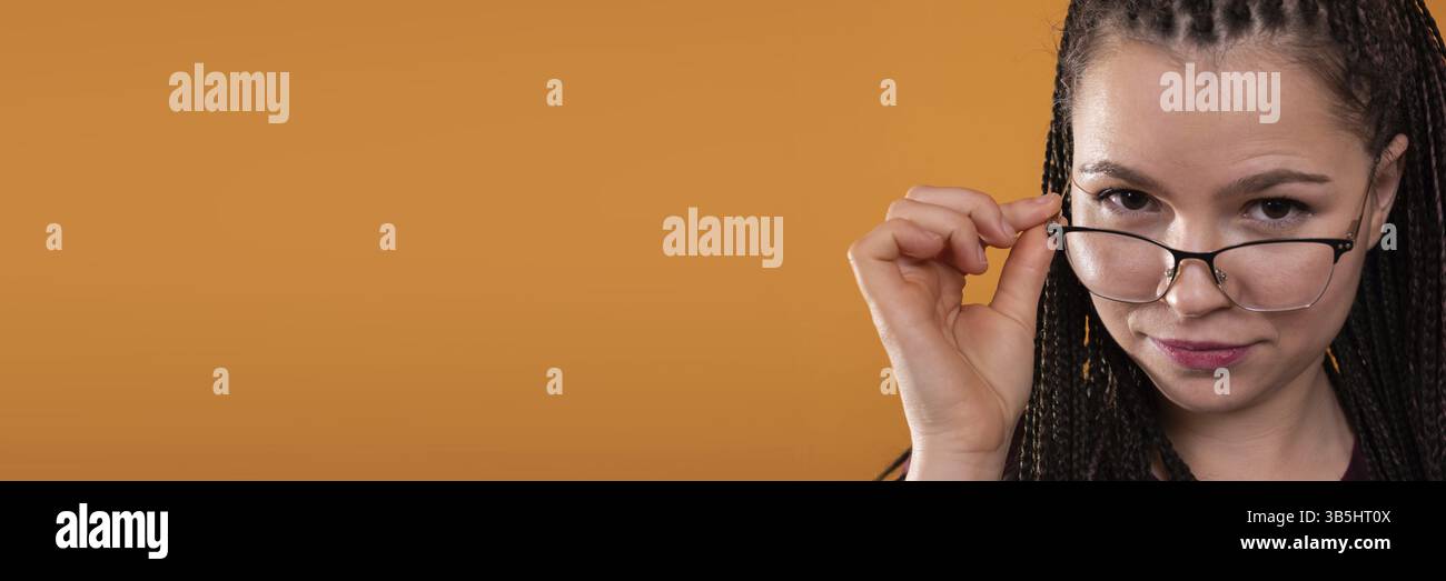 Panoramic. A close-up shot of the very round face of a young woman who ...