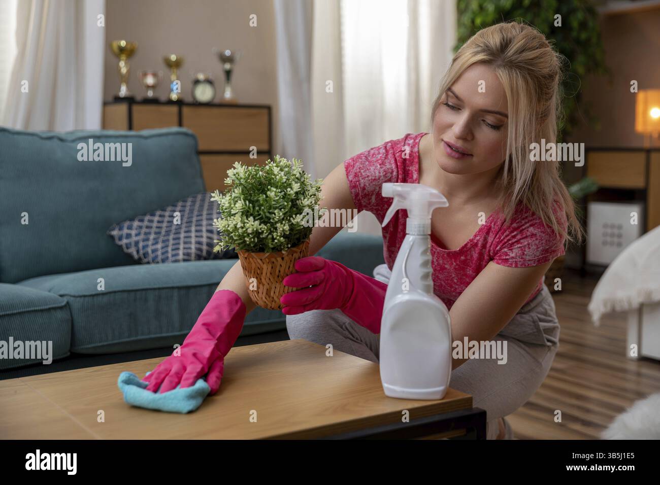 Woman lovingly tending indoor plants hi-res stock photography and ...