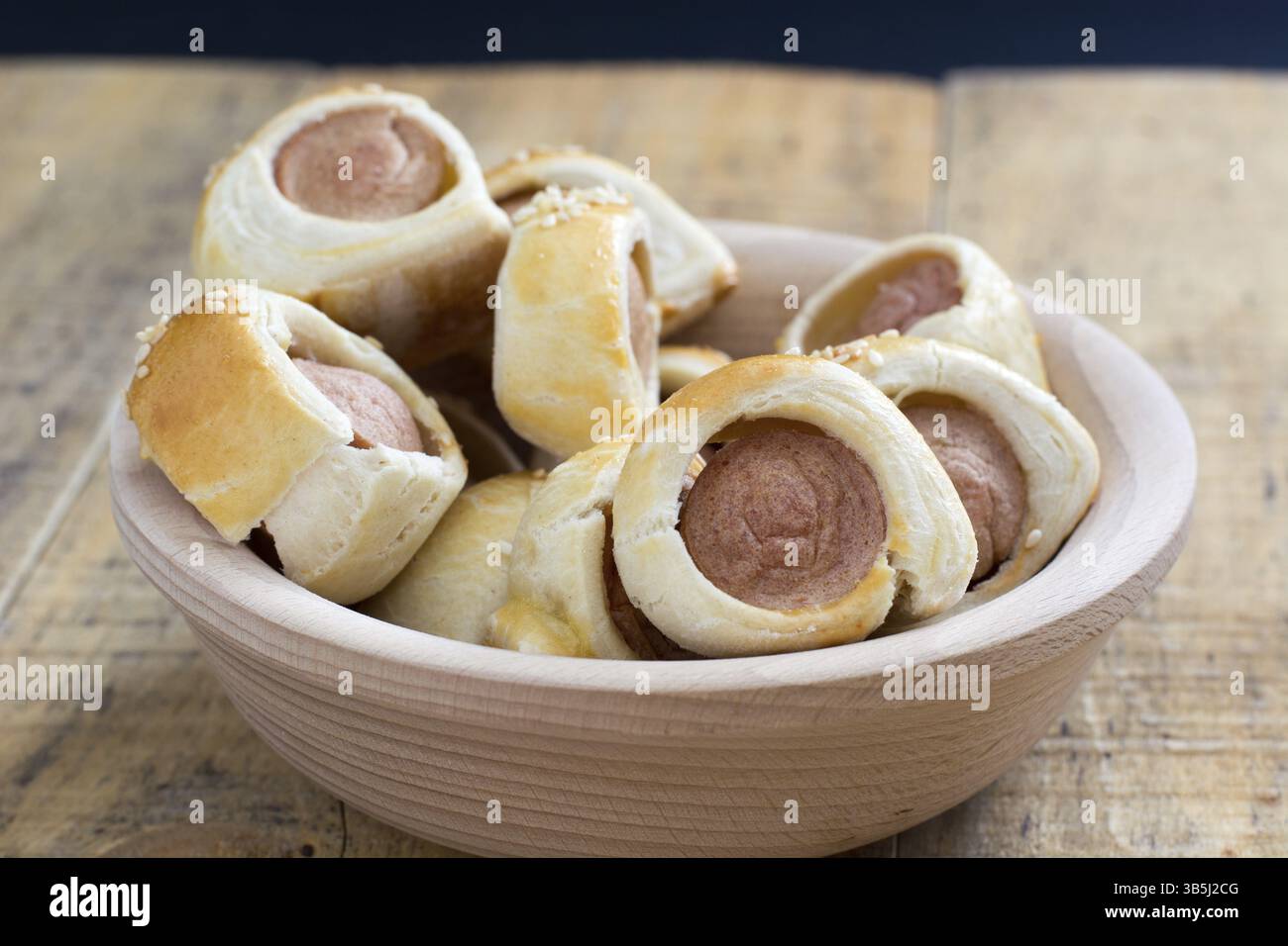 Home made pigs in a blanket. Sausages rolled in croissant dough baked ...