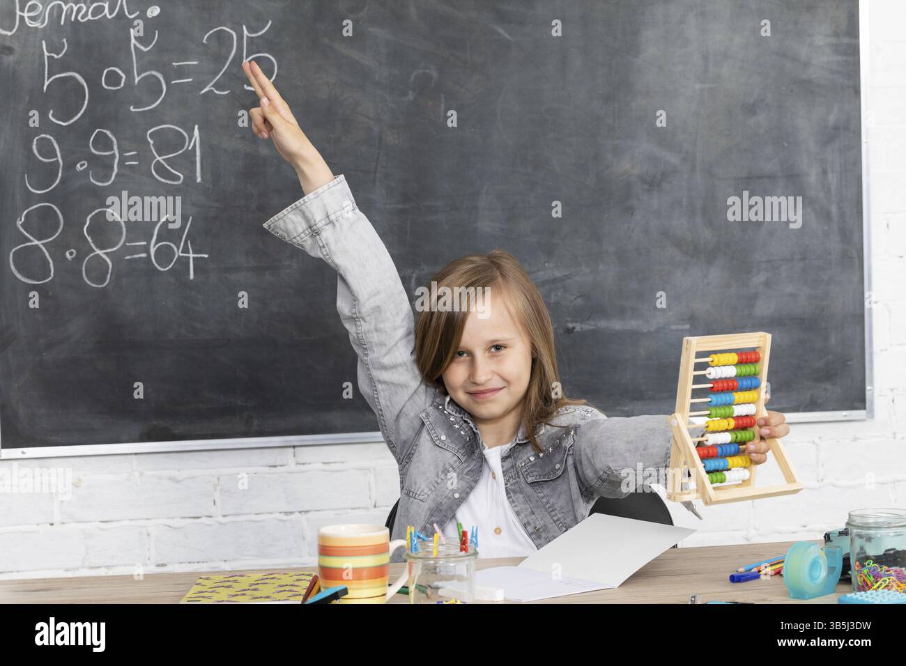 The girl raised her hand in class. The student knows the solution of ...