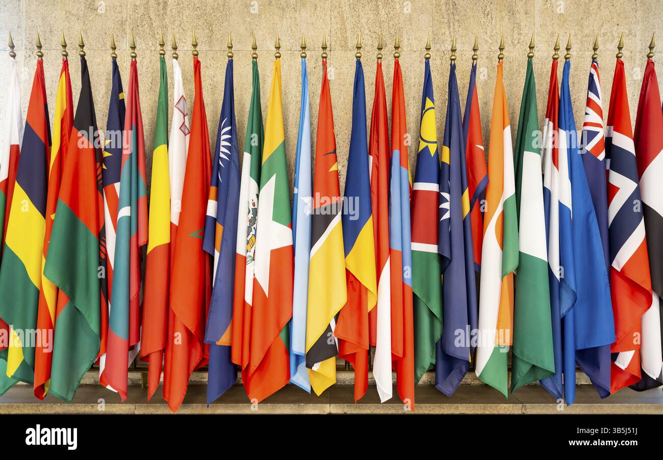 Some world national flags on poles on a wall Stock Photo - Alamy