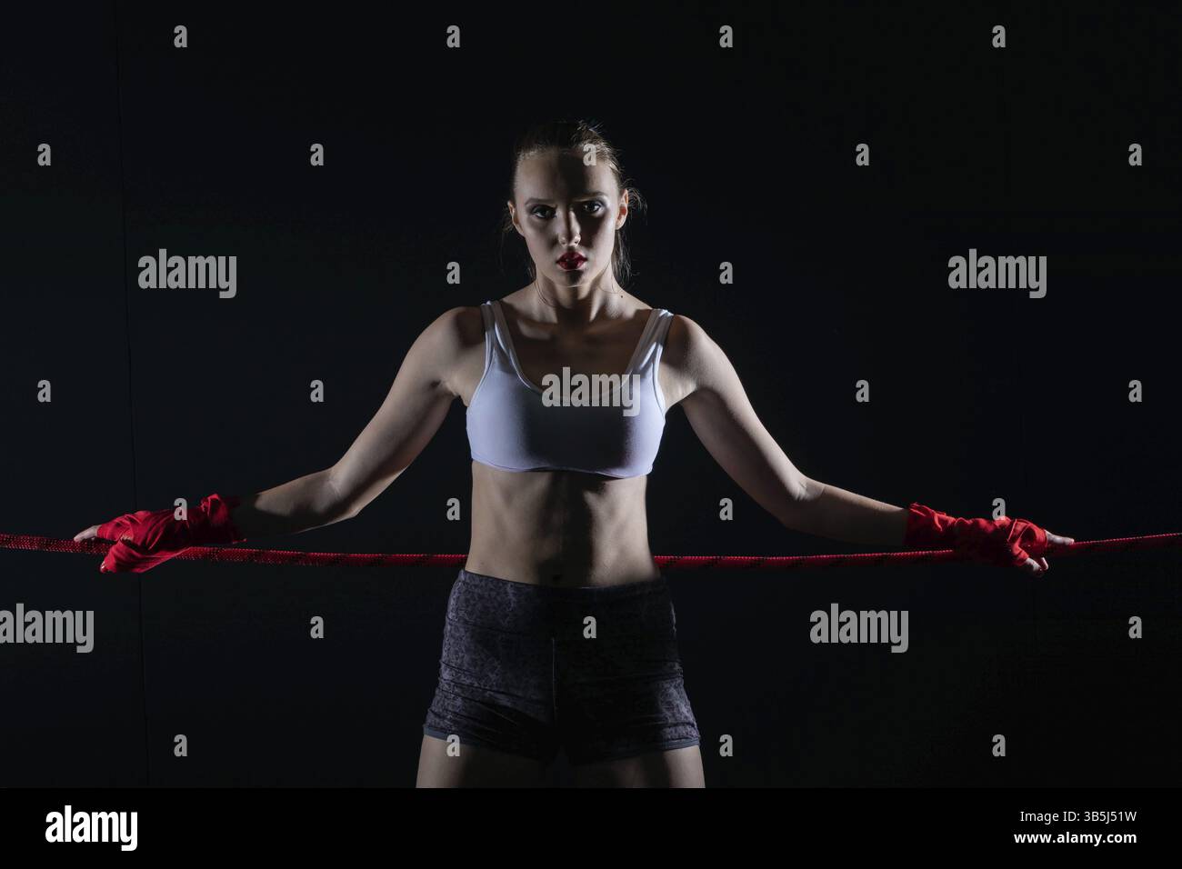 The athlete is based on the red rope of the boxing ring. A determined ...