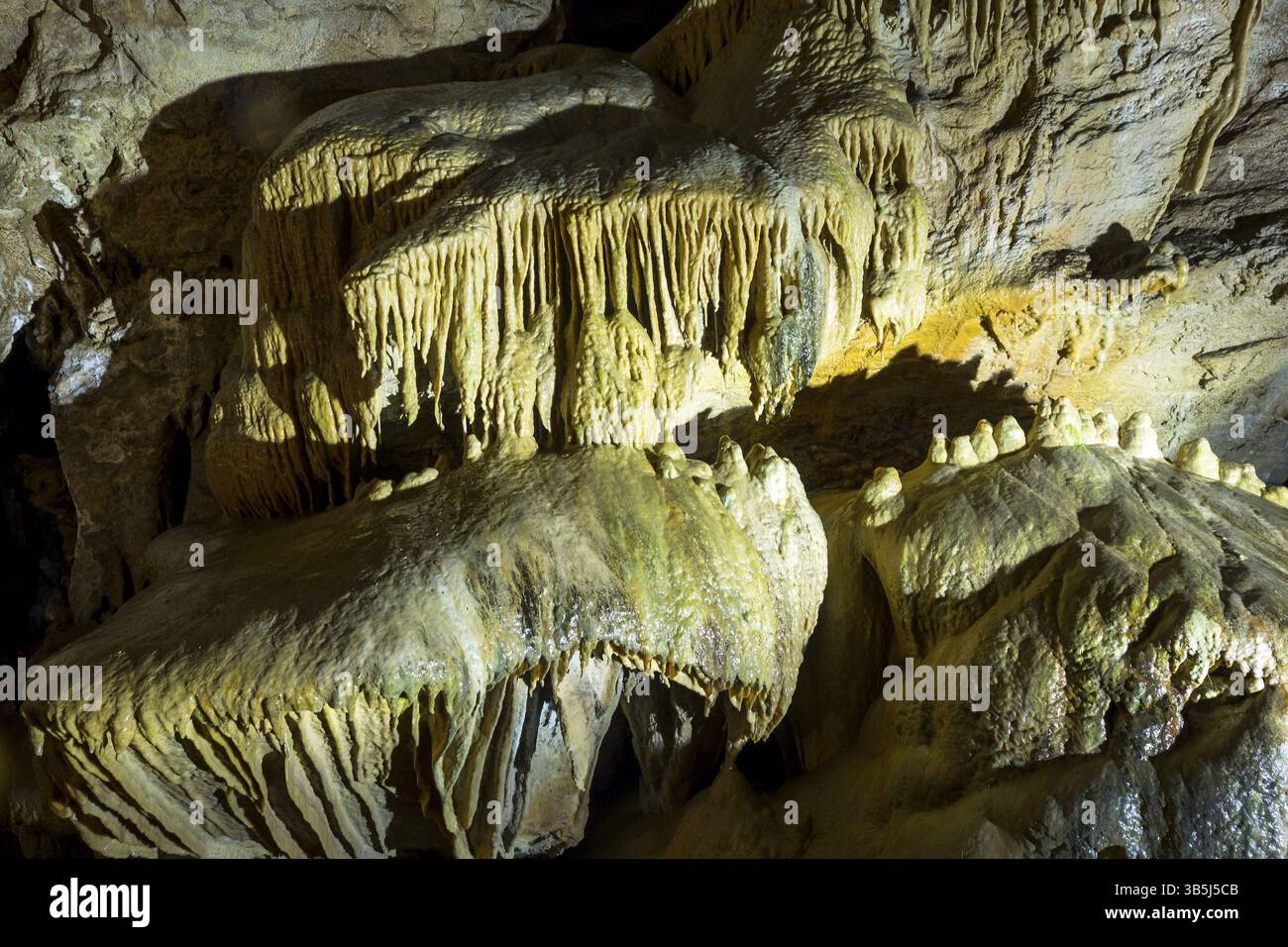 Inside of a beautiful colourful cave. Flowstones, stalactites and ...