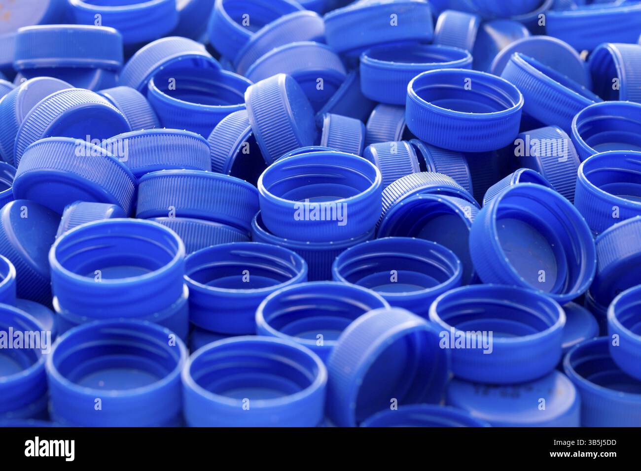 Blue plastic bottle caps. Studio shot. Plastic waste Stock Photo - Alamy