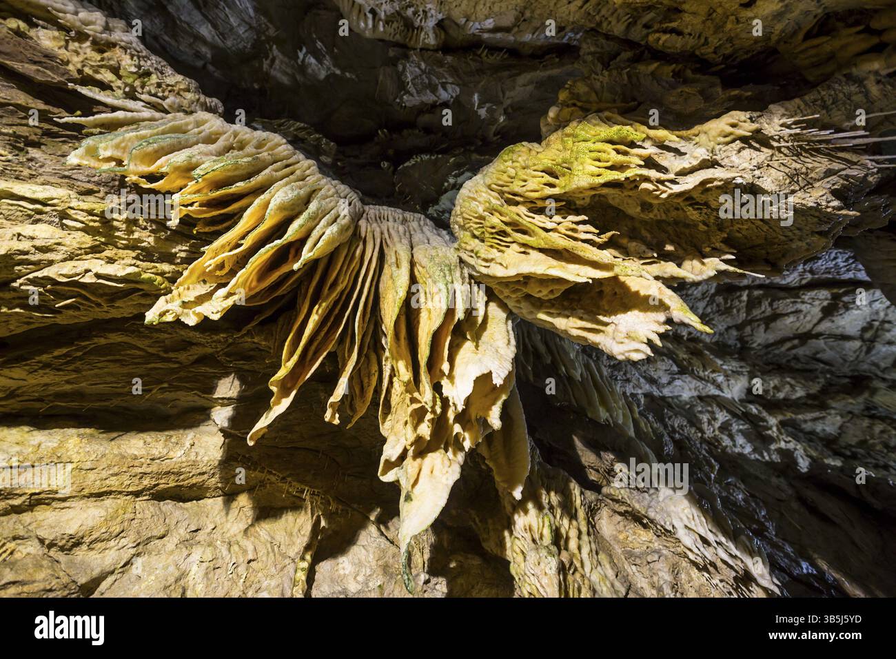 Inside of a beautiful colourful cave. Flowstones, stalactites and ...