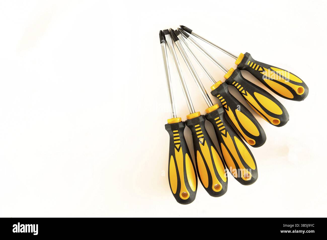 Set of screwdrivers with rubber black and yellow handles isolated on a ...