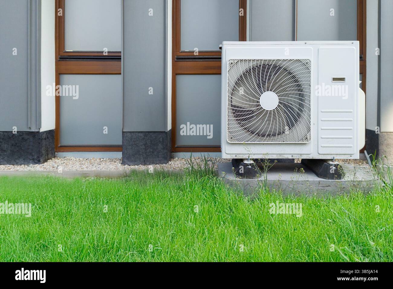 Outdoor air conditioner unit on building wall Stock Photo - Alamy