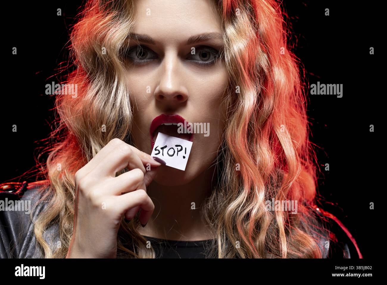 A striking image featuring a model holding a 'STOP' sign, embodying ...