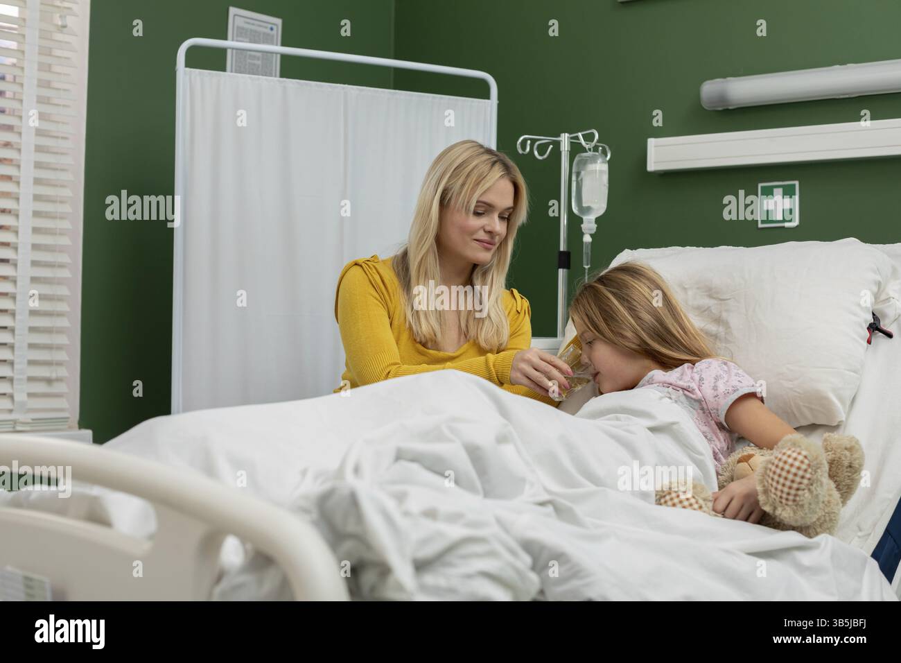 A tender scene of a mother comforting her daughter in a hospital ...