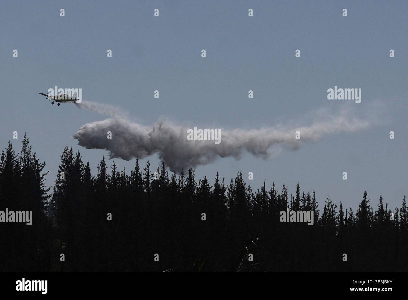 A firefighting aircraft works to extinguish a wildfire that has ravaged ...