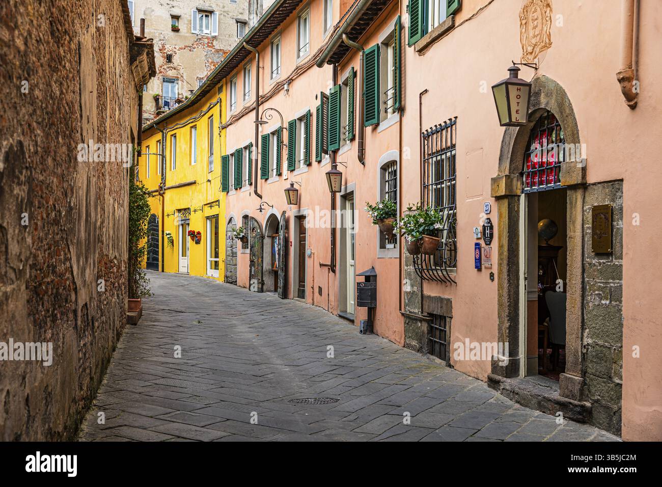 Narrow cobbled alley, houses with pastel-coloured facades, historic ...