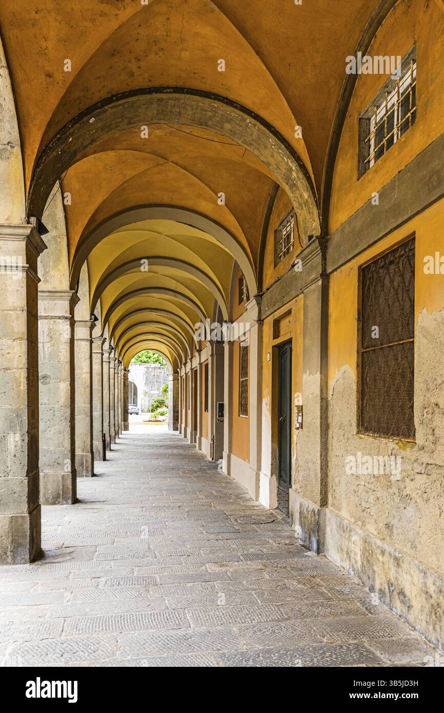 Arched arcades in Via Elisa, historic city centre, Lucca, Tuscany ...