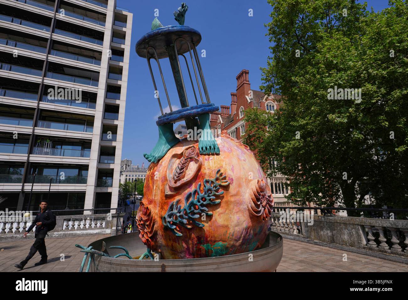 A man looks towards an artwork by Candida Powell-Williams called ...