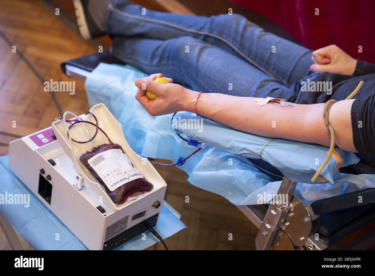 The hand of a man who donates blood. Male donor gives blood in a mobile ...