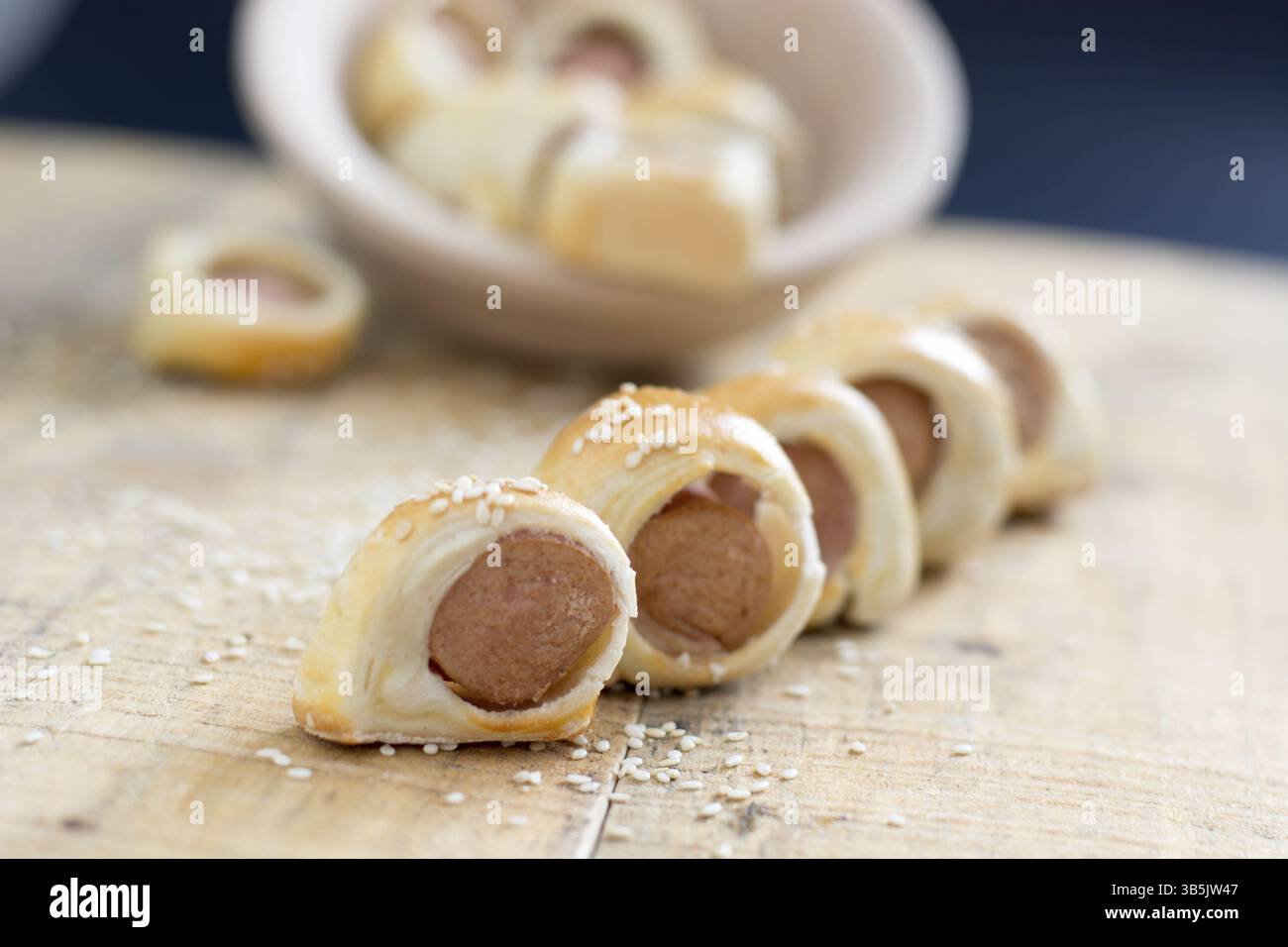 Home made pigs in a blanket. Sausages rolled in croissant dough baked ...