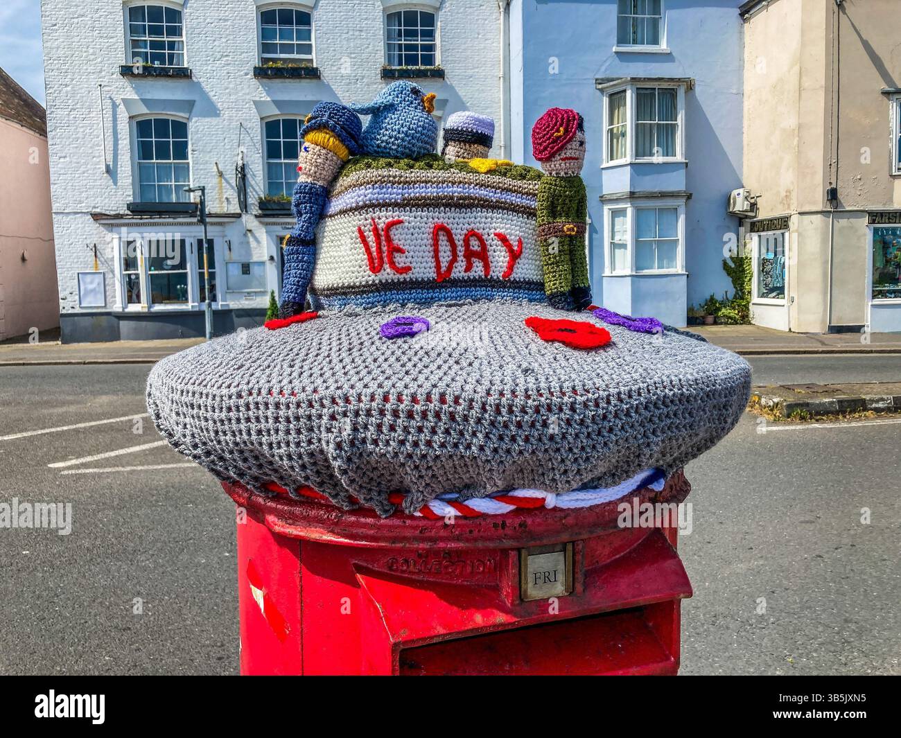 Close-up of a Red Post Box fitted with a knitted celebration of the ...
