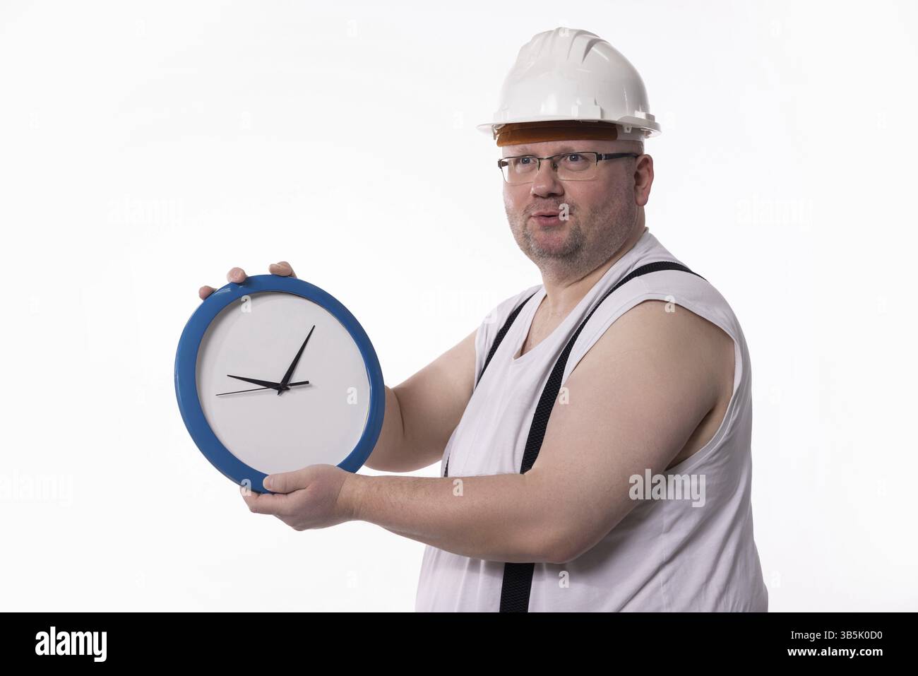 A light-hearted image of a construction worker showcasing a wall clock ...